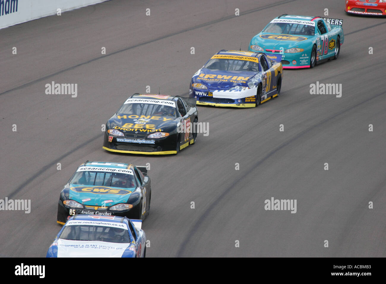 V8 Nascar type stock cars racing on a banked oval circuit Stock Photo ...
