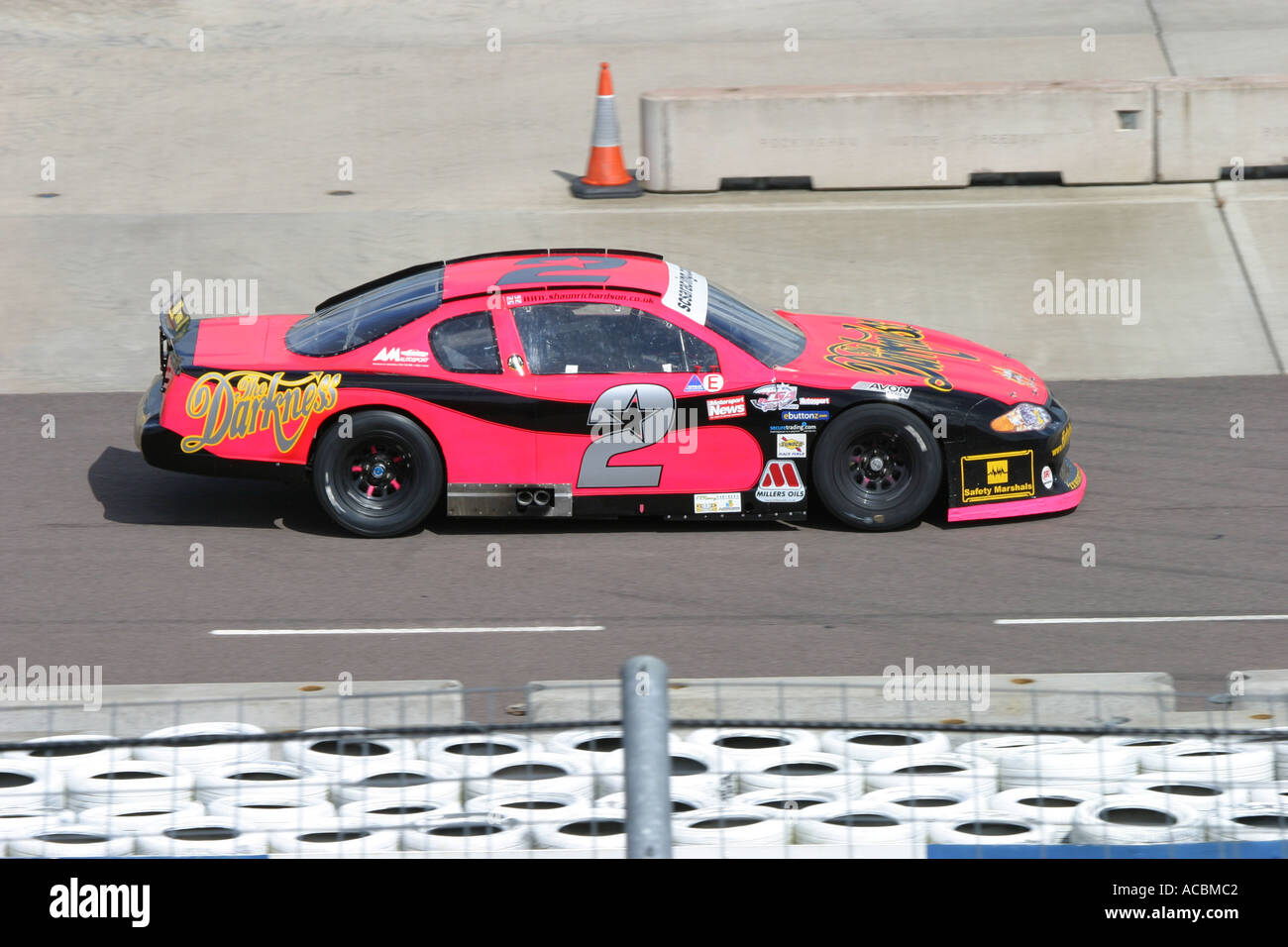 V8 Nascar type stock cars racing on a banked oval circuit Stock Photo ...