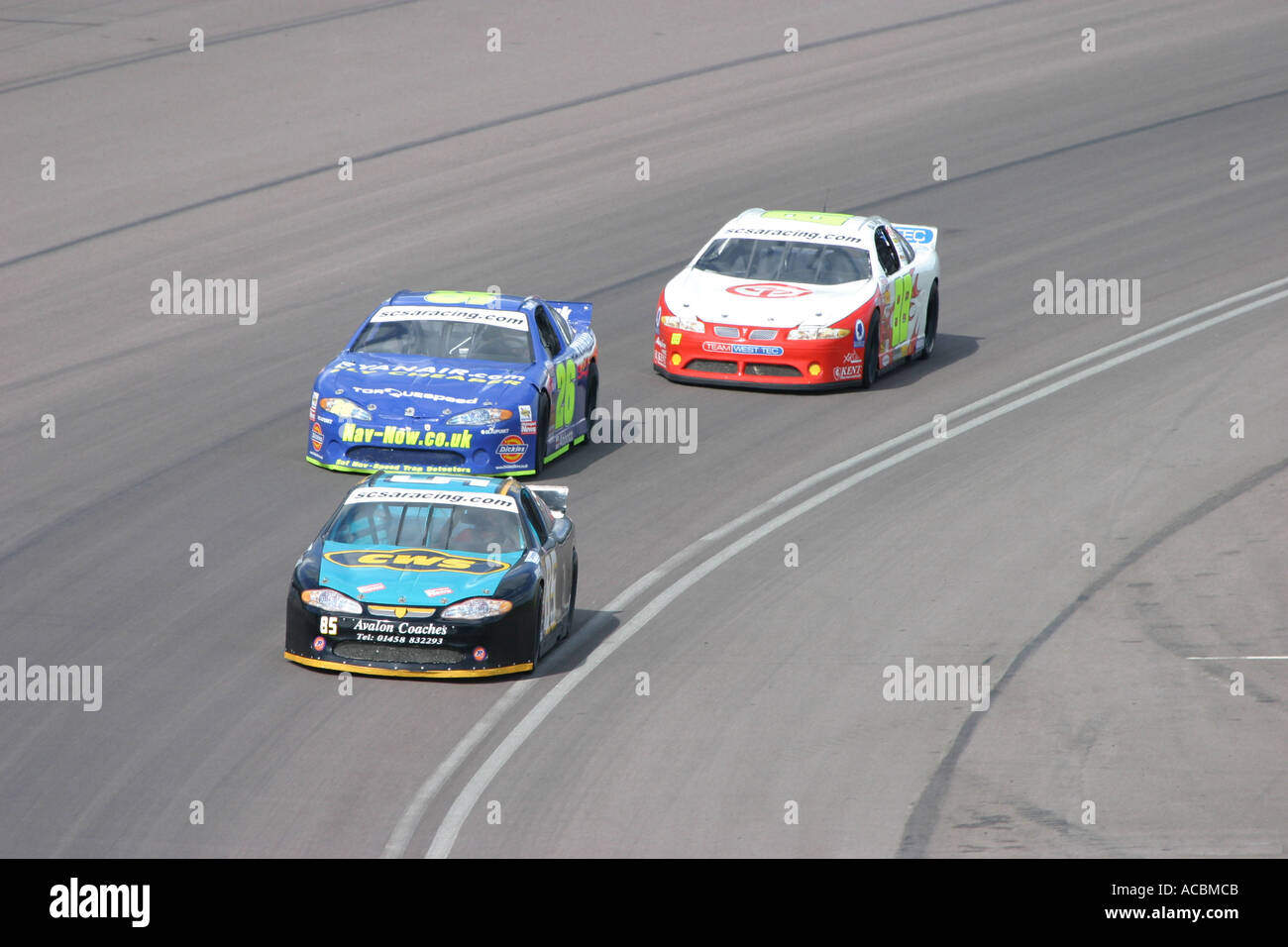 V8 Nascar type stock cars racing on a banked oval circuit Stock Photo ...