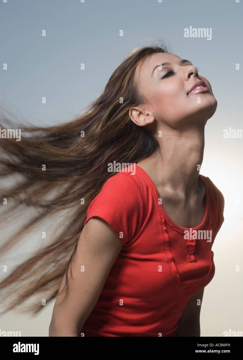 Side profile of a young woman standing and smiling Stock Photo - Alamy