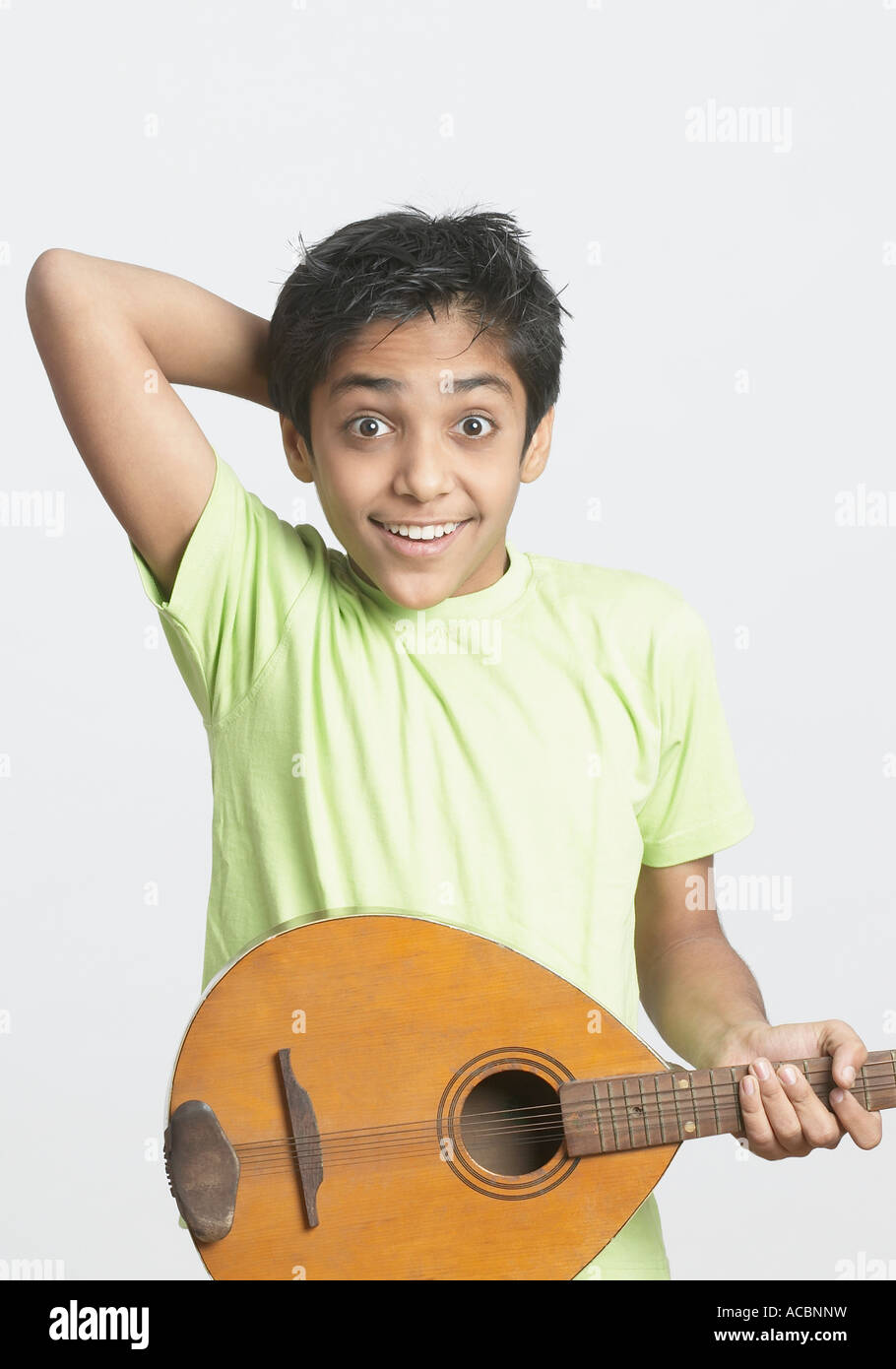 Portrait of a boy holding a guitar Stock Photo - Alamy