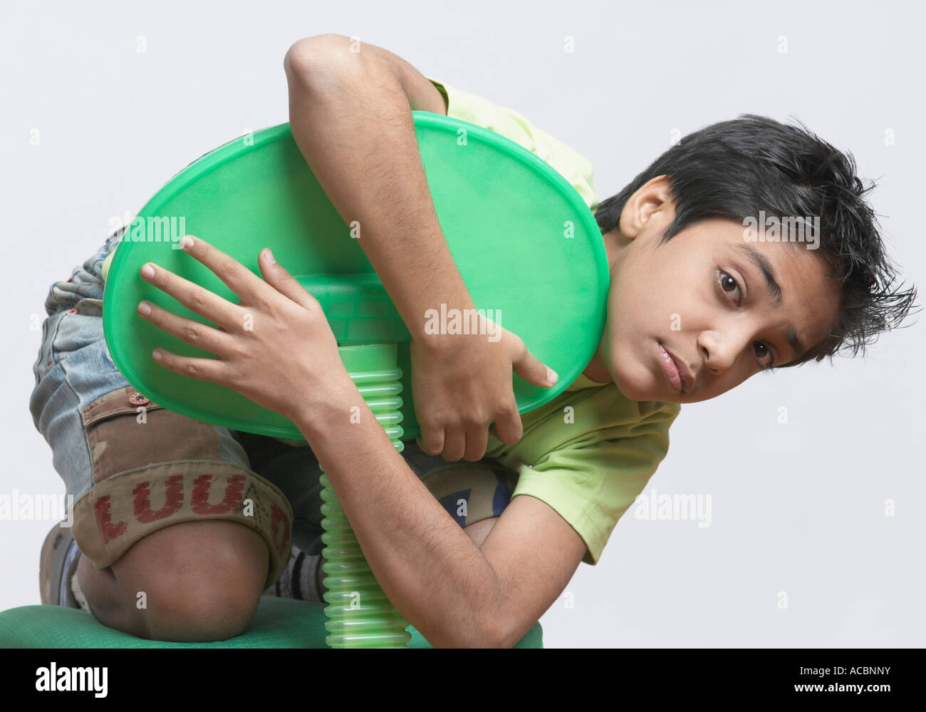 Portrait of a boy holding a chair Stock Photo - Alamy