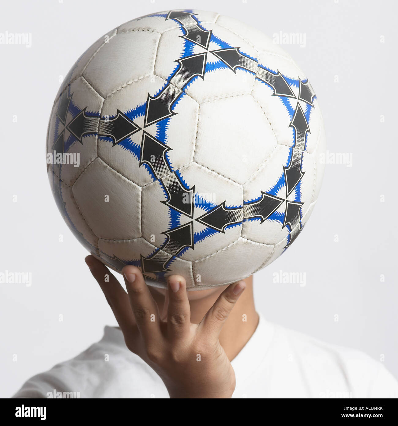 Close-up of a boy covering his face with a soccer ball Stock Photo - Alamy