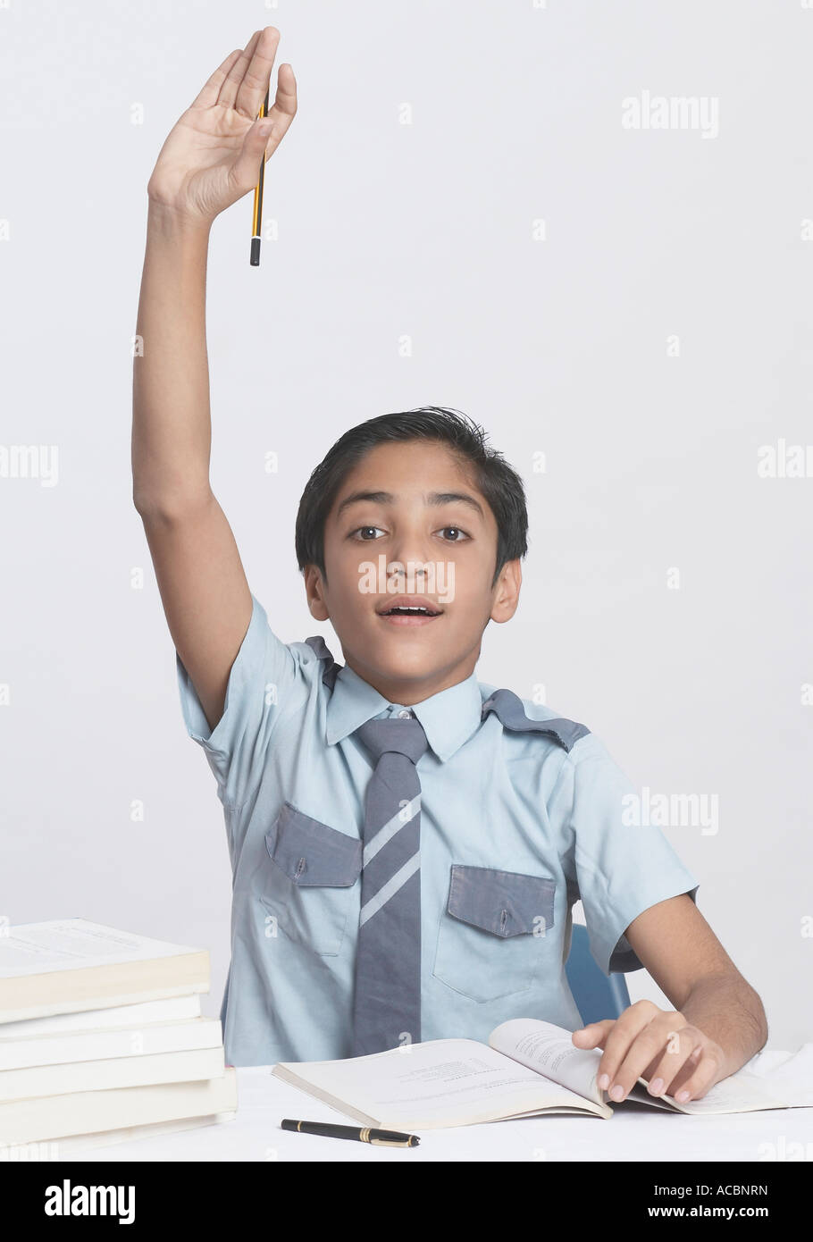 Portrait of a boy raising his hand Stock Photo - Alamy
