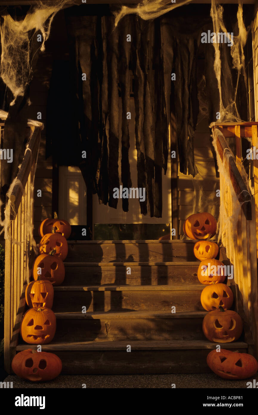 Steps and porch decorated for Halloween with carved pumpkins on steps ...