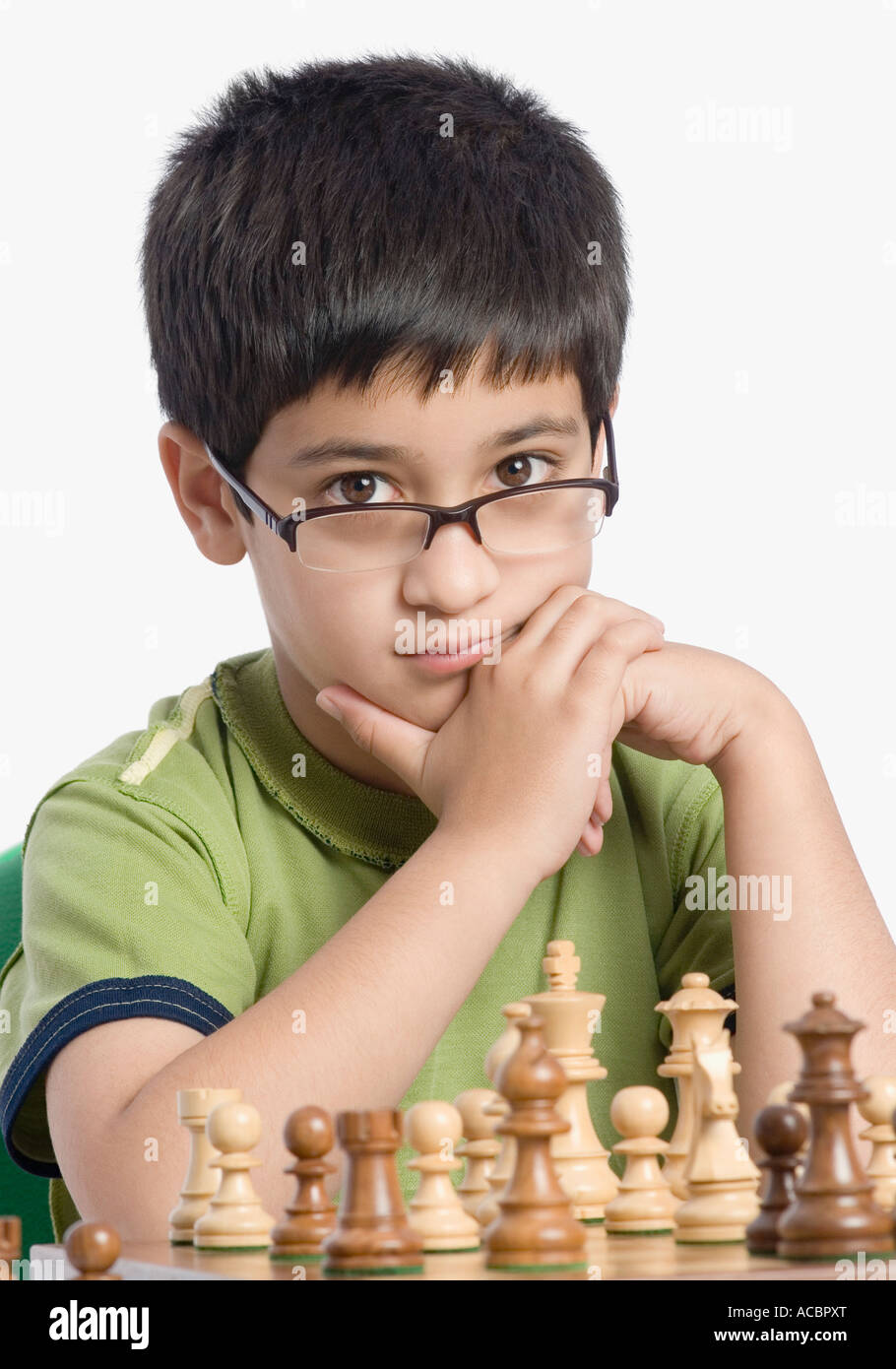 Close-up of a boy playing chess with his hand on his chin Stock Photo ...