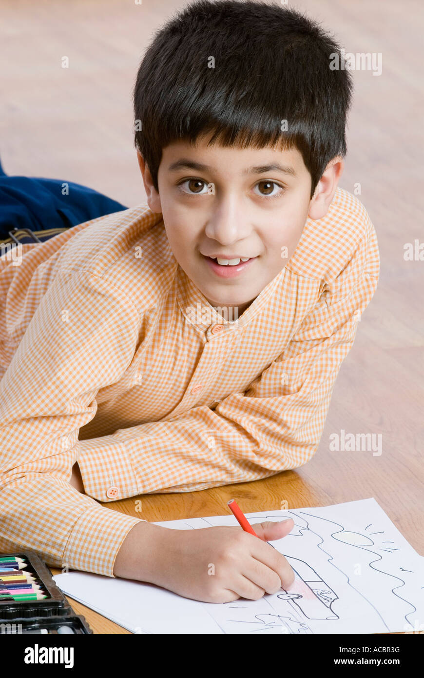 Portrait of a boy drawing with a color pencil Stock Photo - Alamy
