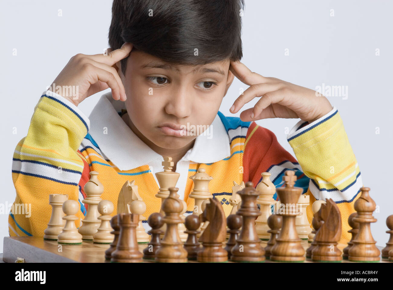Close-up of a boy playing chess Stock Photo - Alamy