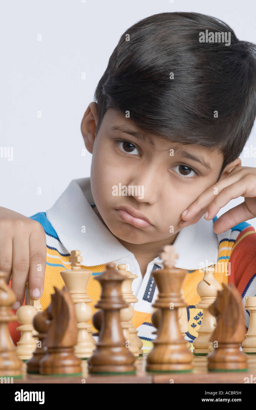 Portrait of a boy playing chess Stock Photo - Alamy