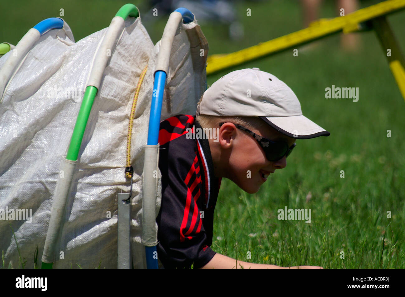 Boy crawling out of textile tunnel Stock Photo - Alamy