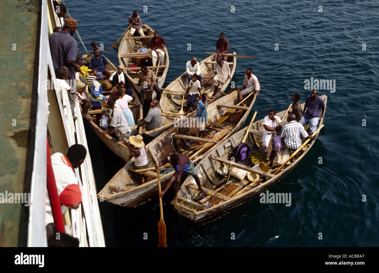 Passenger of steamboat MV Liemba looking down on people boarding Lake ...