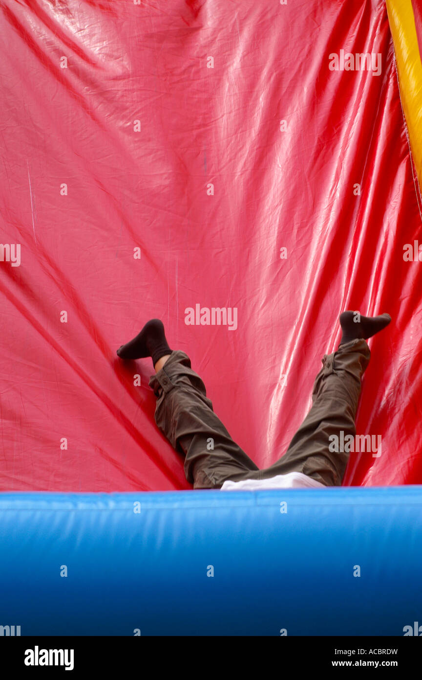 Boy sliding on inflatable red slide Stock Photo - Alamy