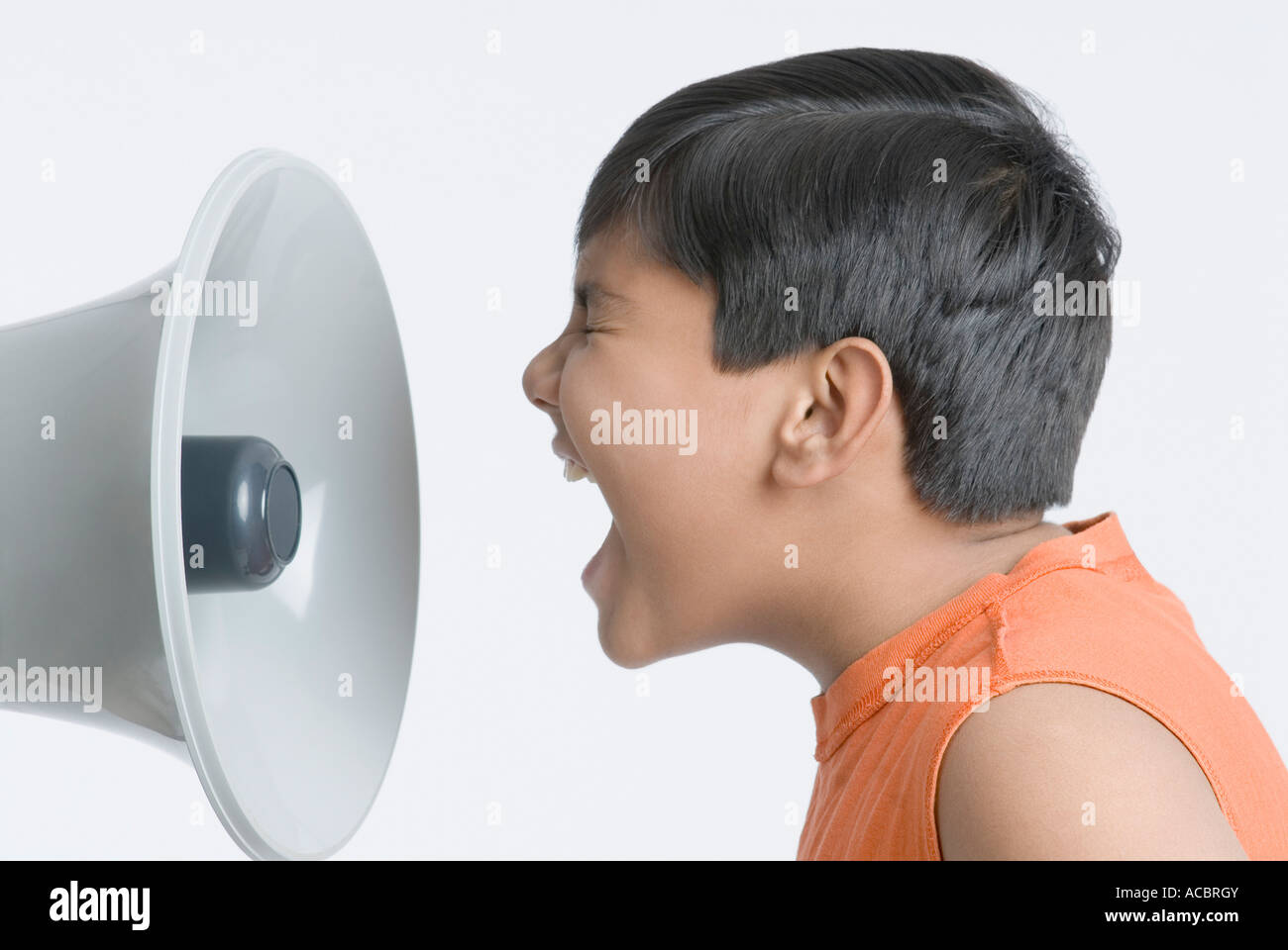 Side profile of a boy shouting into a megaphone Stock Photo - Alamy