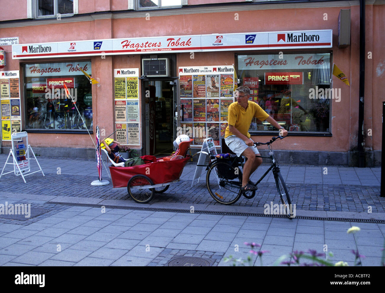 A SWEDISH FATHER TOWS HIS CHILDREN BEHIND A BICYCLE Stock Photo - Alamy
