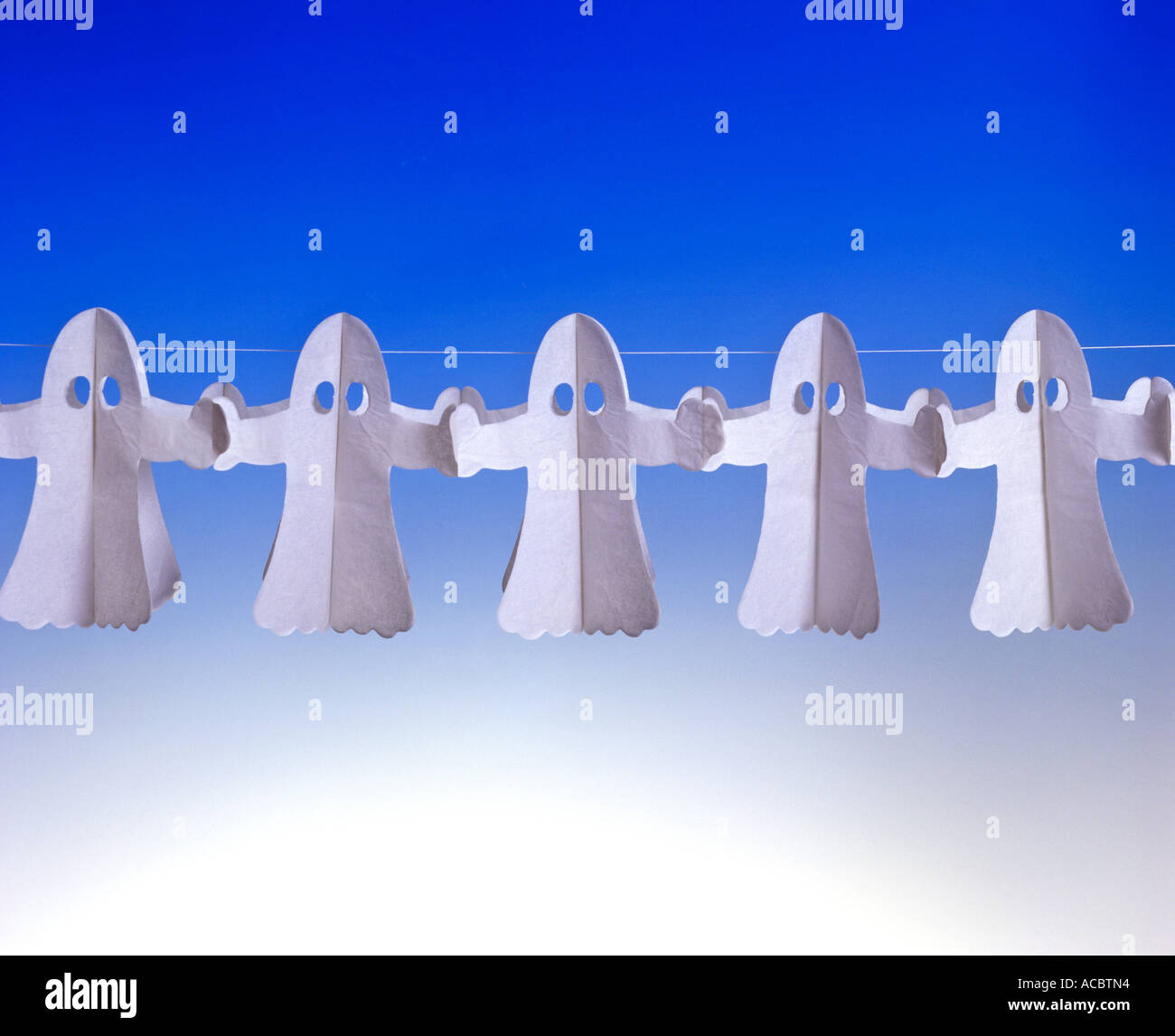 paper cut out of silhouettes of little ghosts Stock Photo - Alamy
