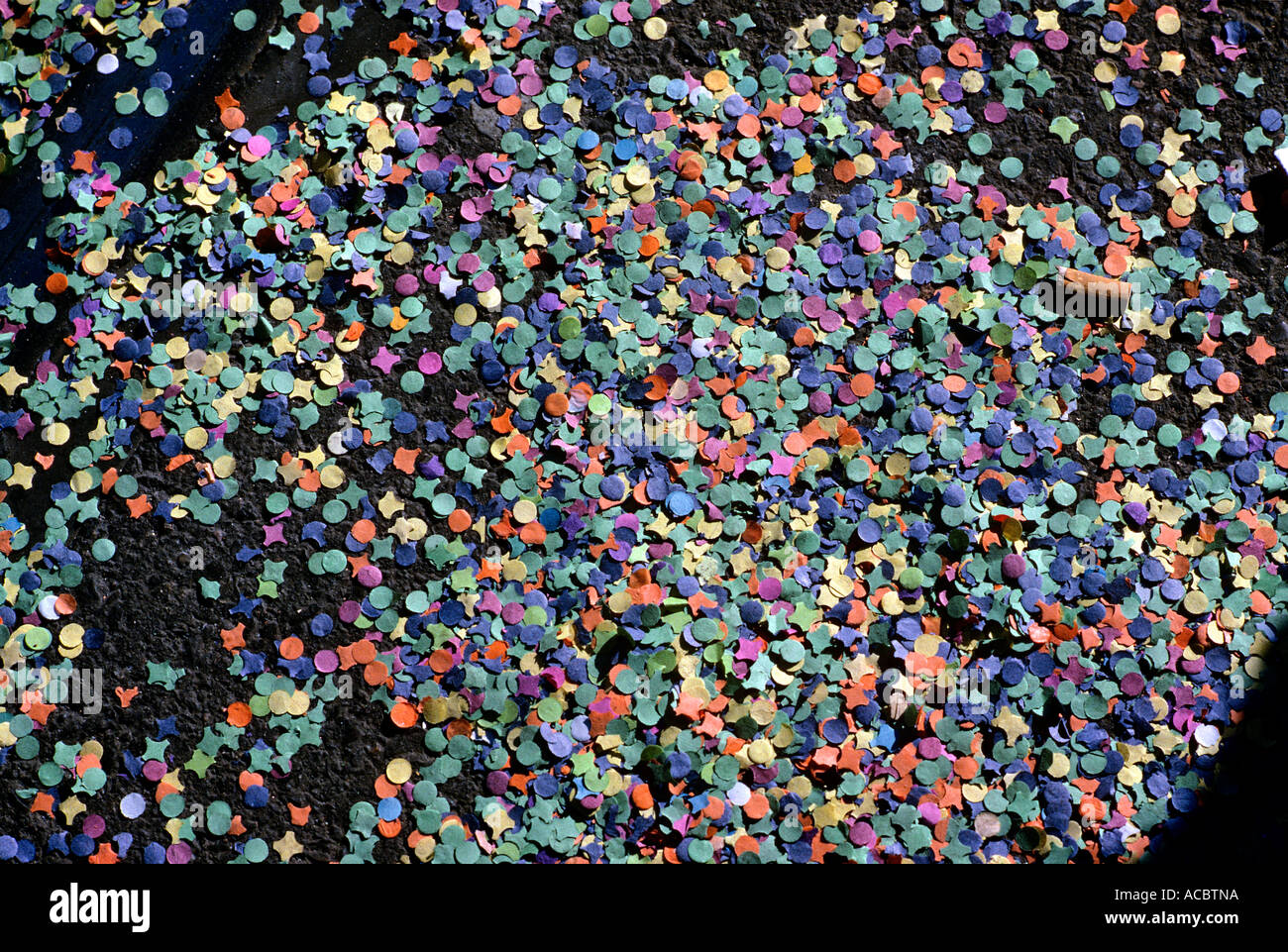 confetti covered square after carnival parade Stock Photo - Alamy