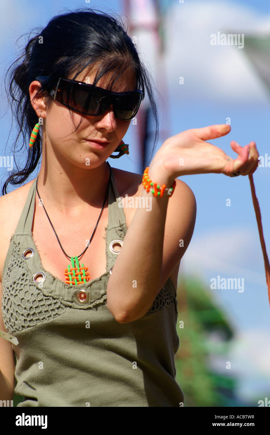 Happy teenage girl dancing and poi spinning at rave party Hilltop 2007 ...