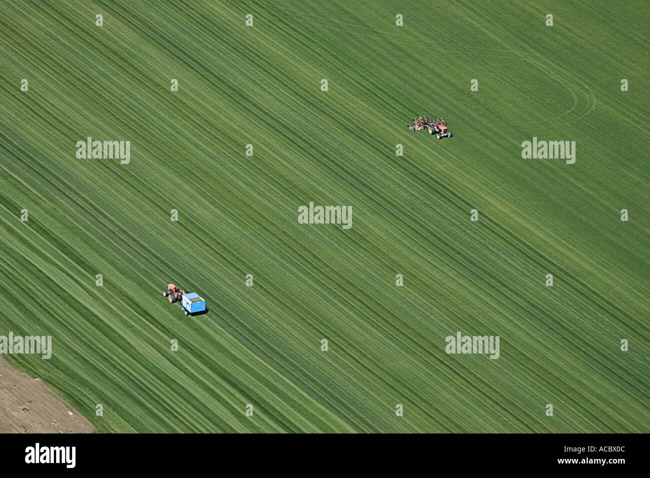 Aerial photo of farmer on tractor harvesting alphalpha Stock Photo - Alamy