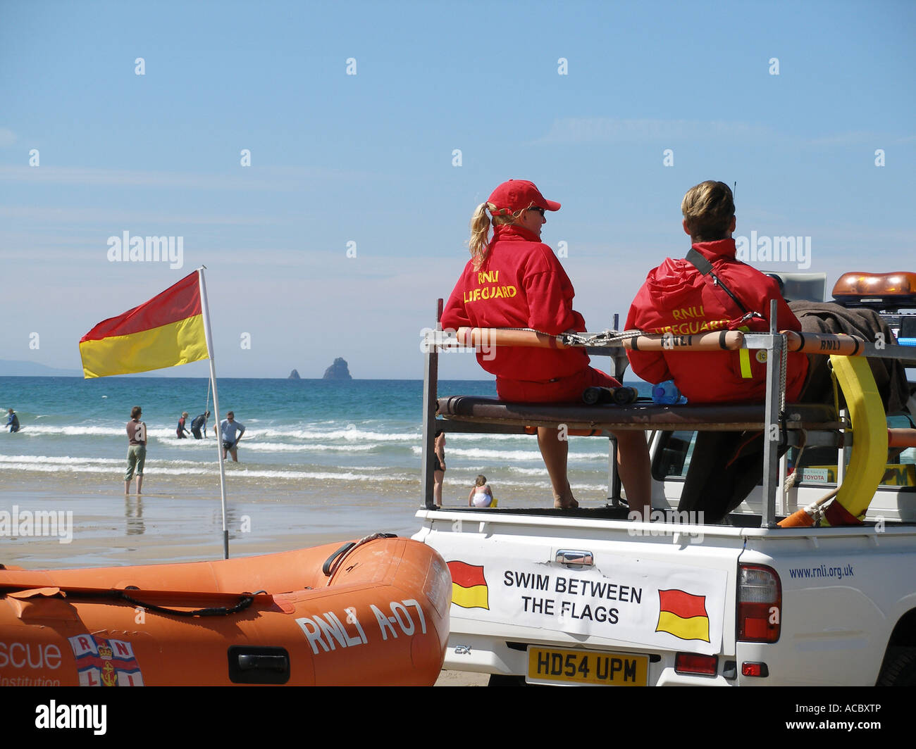 Perranporth beach lifeguards watching busy summer beach and swimmers ...