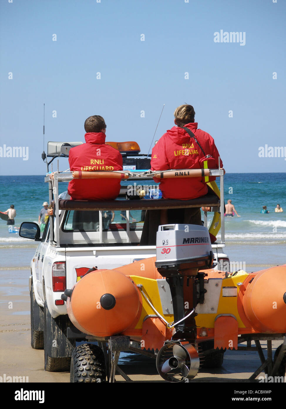 Cornish lifeguards watching busy summertime beach and holidaymakers ...