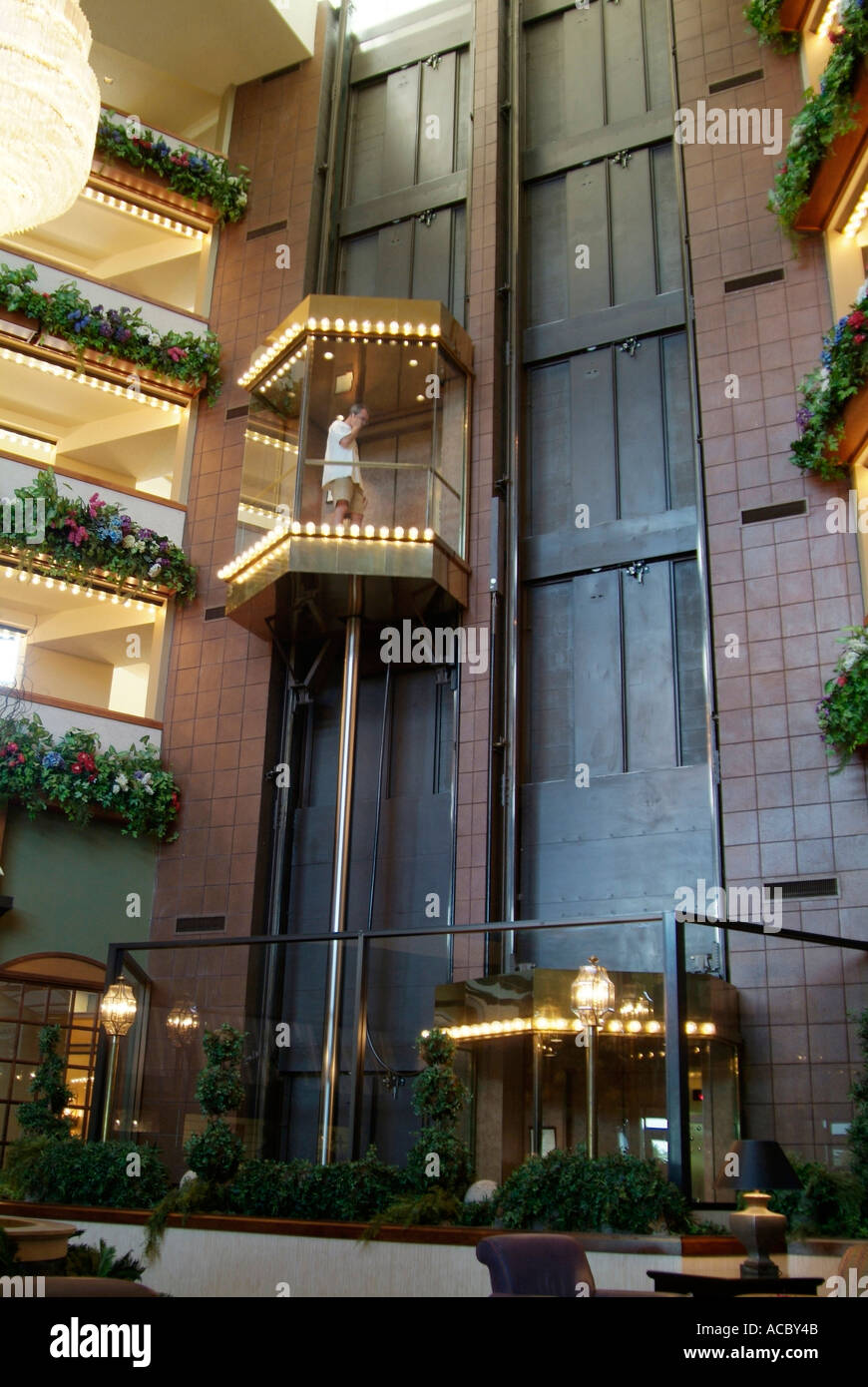 Exterior elevator transports people between floors in a Hilton Hotel ...