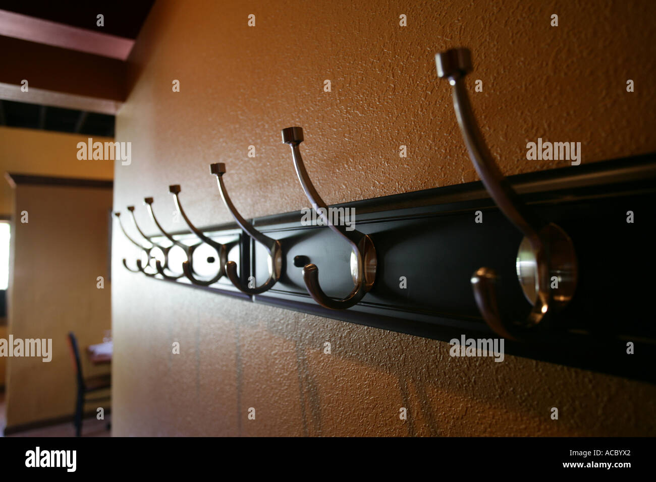 Rows of Coat hooks in a restaurant Stock Photo - Alamy