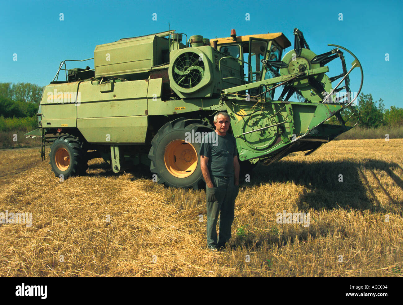 A combine driver near his harvesting machine Stock Photo - Alamy
