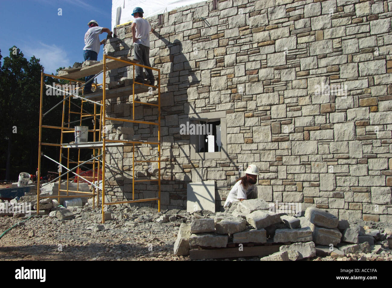 Stone masons building limestone wall Stock Photo - Alamy