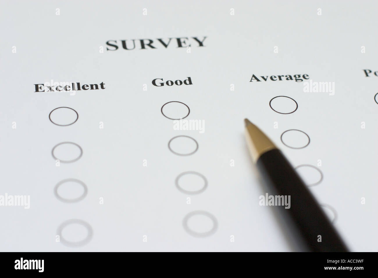 pen on survey form with the words excellent good average Stock Photo ...