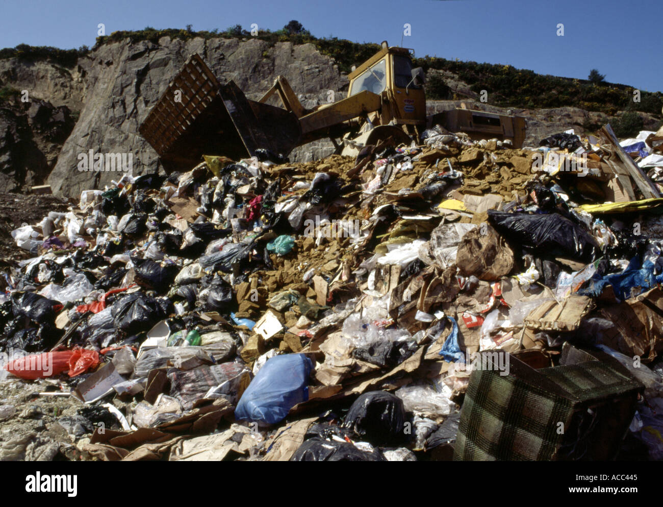 A JCB moves garbage on a rubbish tip Stock Photo - Alamy