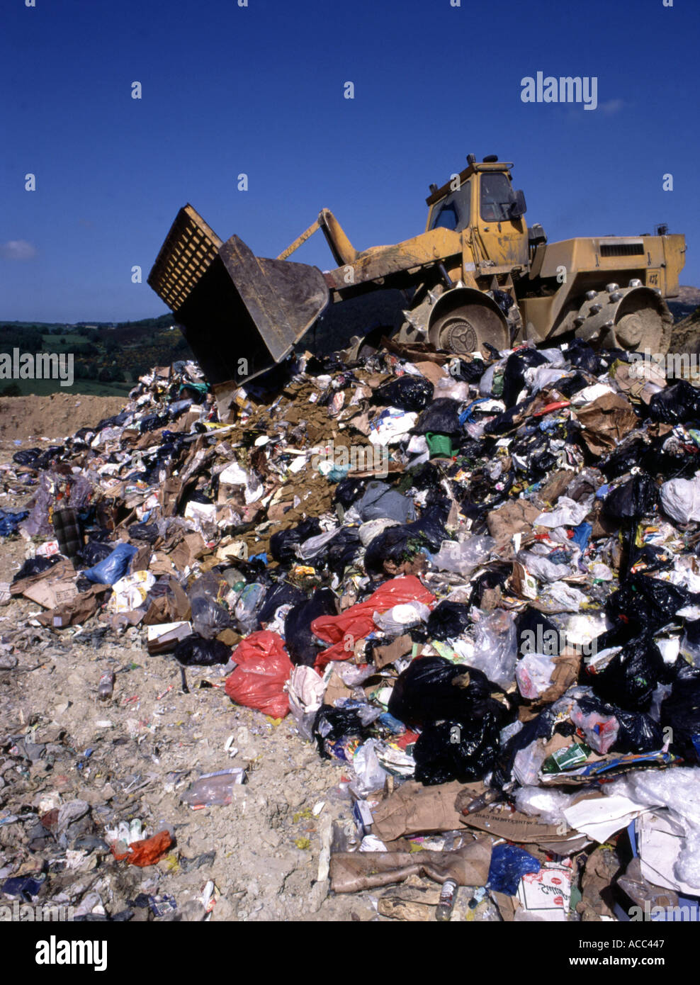 A JCB moves garbage on a rubbish tip Stock Photo - Alamy