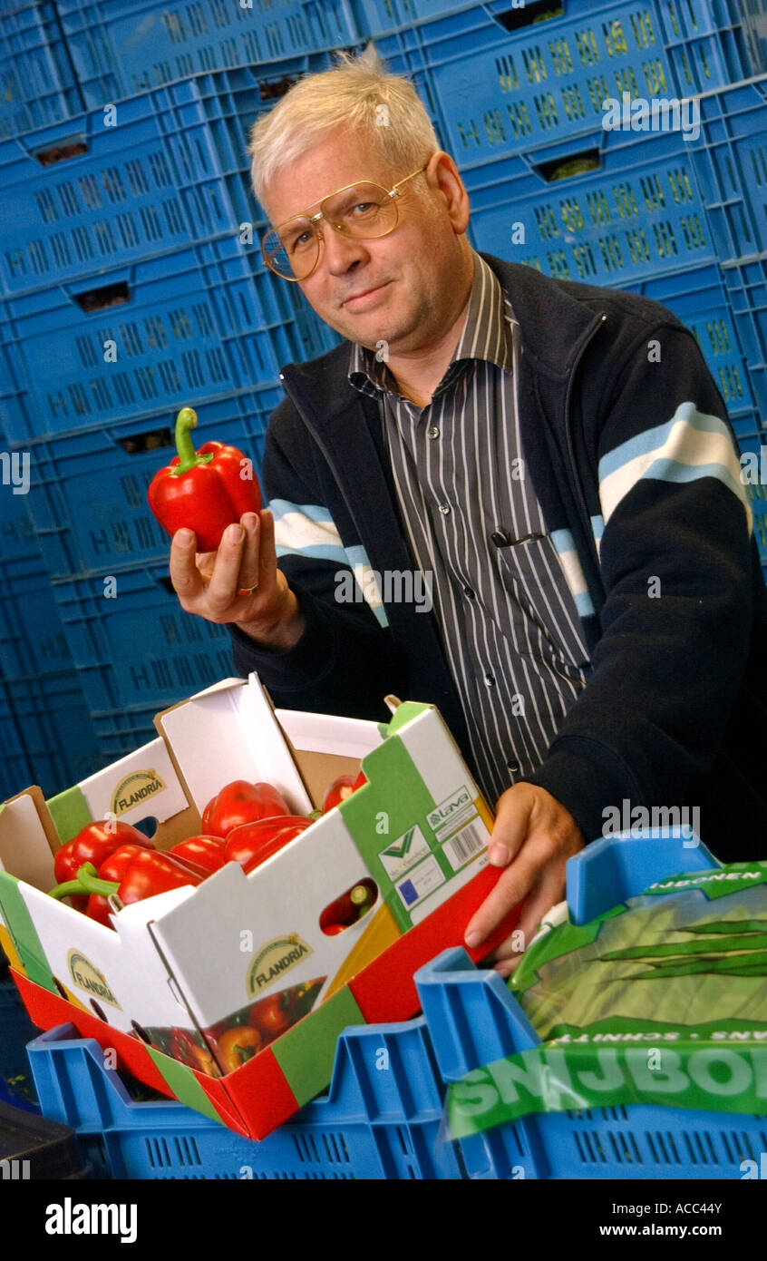 Market stall owner with red peppers Stock Photo - Alamy