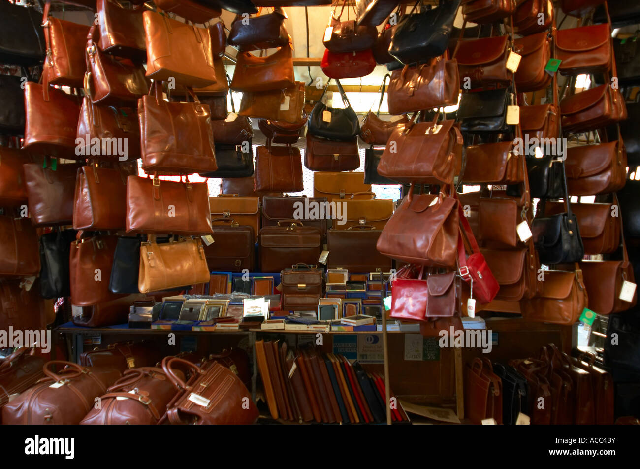 Market stall and seller with leather purses Italy Stock Photo - Alamy