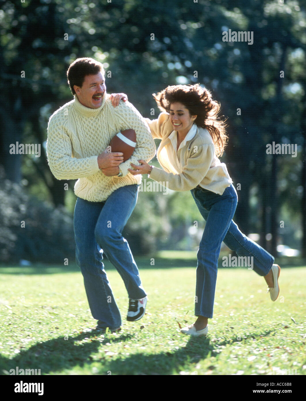 Young couple playing football hi-res stock photography and images - Alamy