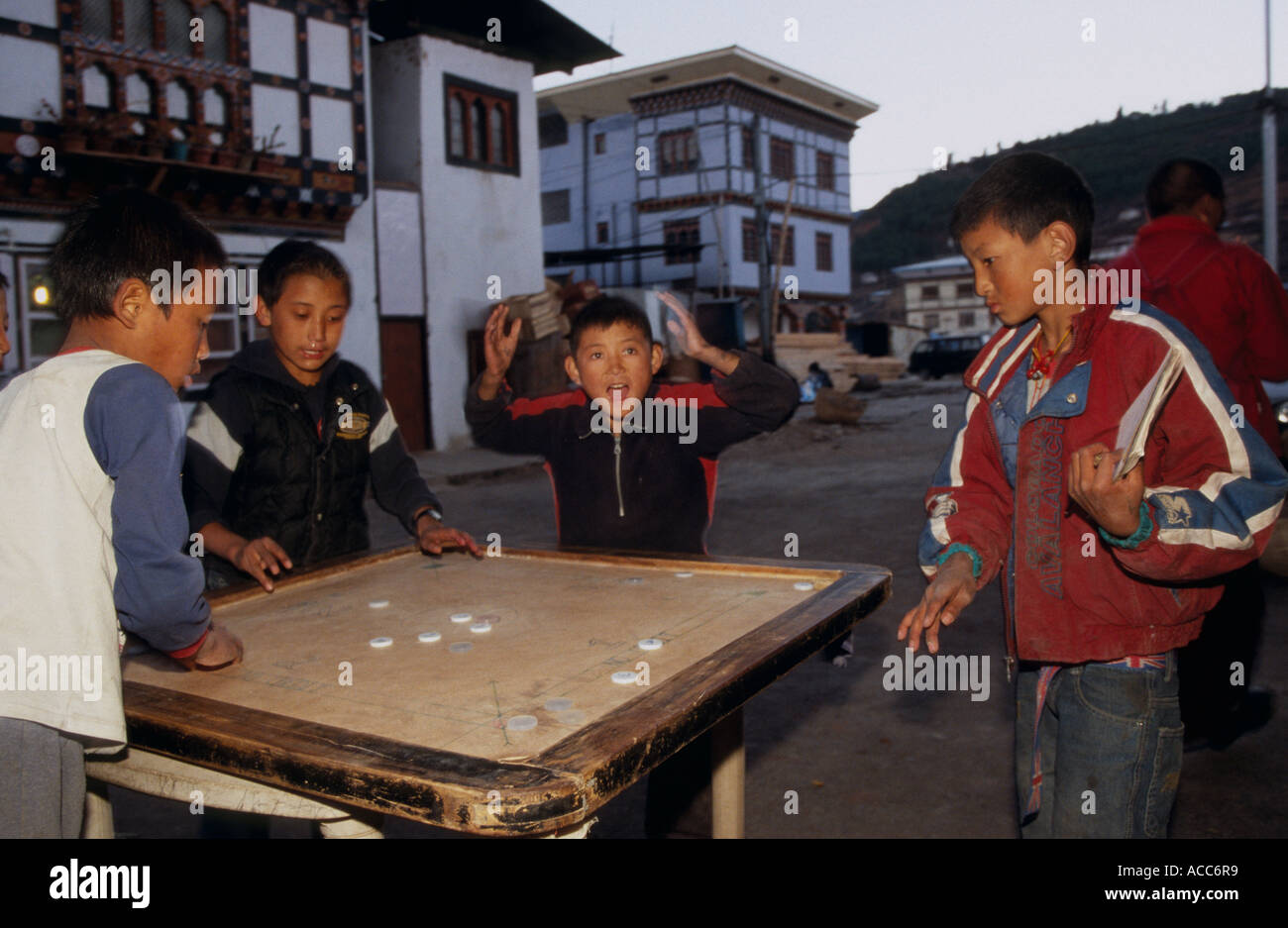 Children enjoying Carrom board game, Paro, Bhutan Stock Photo - Alamy