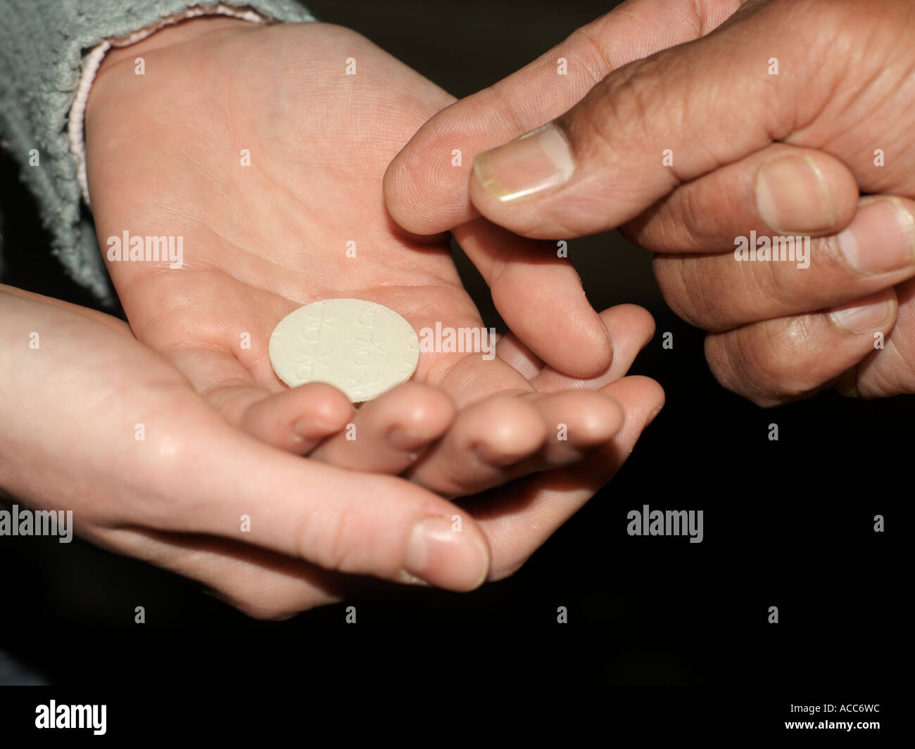 Close up of Communion Wafer being Placed in Hand At communion England ...