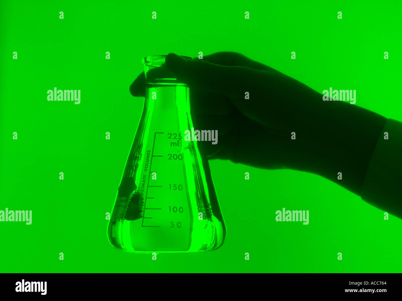 hand holding beaker containing liquid Stock Photo - Alamy