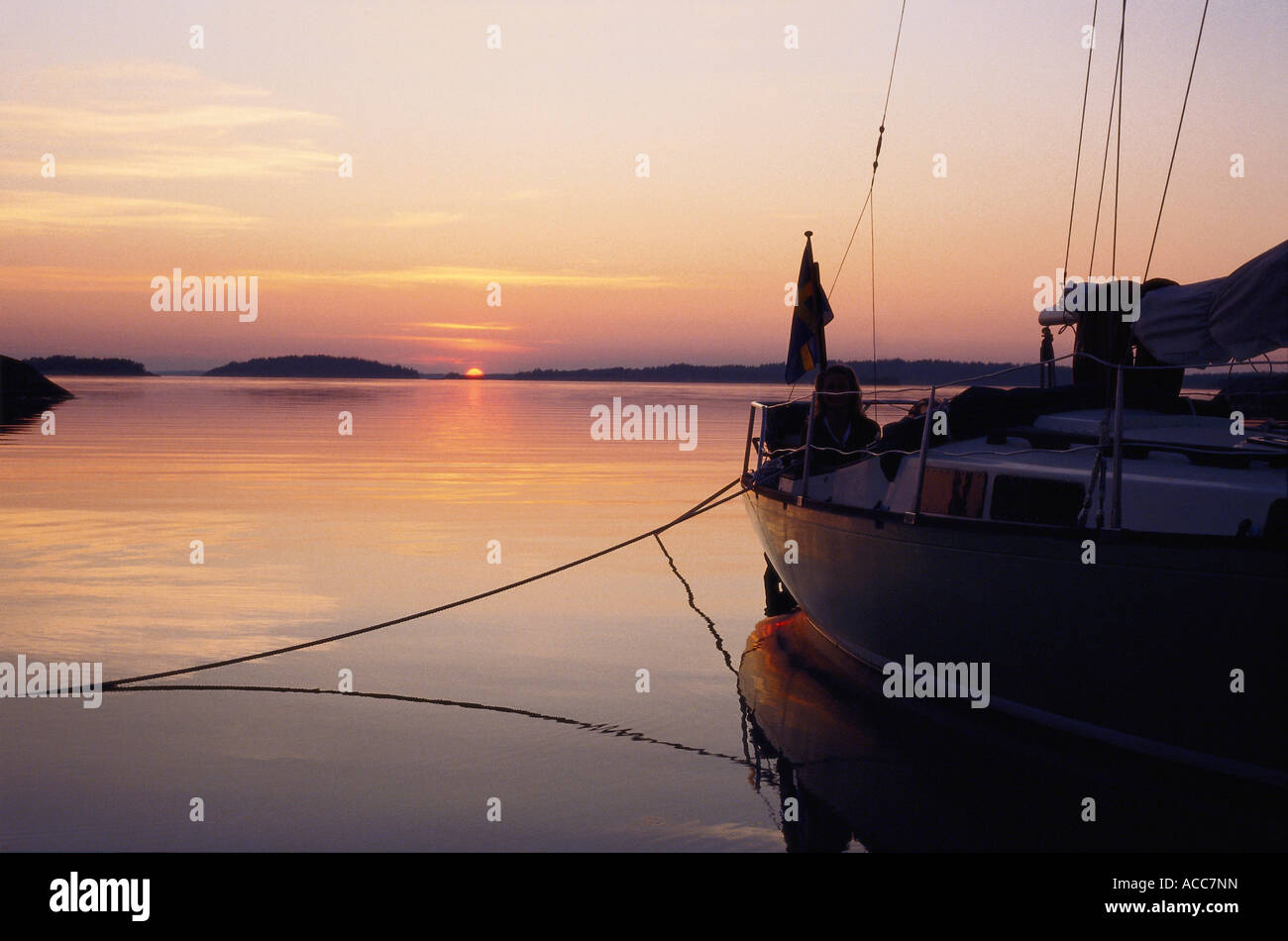 A sailing boat in sunset Stock Photo - Alamy
