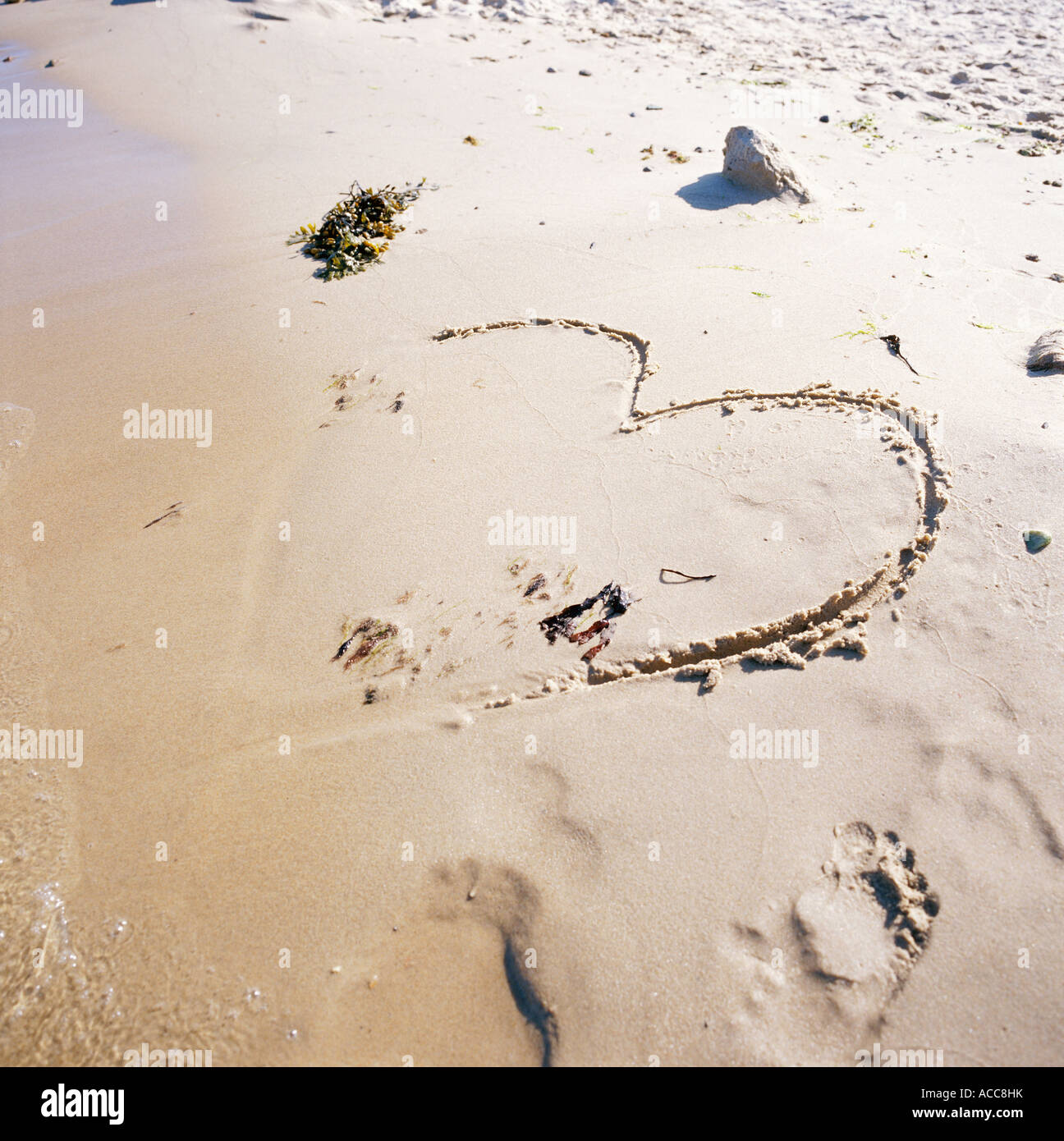 A heart imprinted in sand Stock Photo - Alamy
