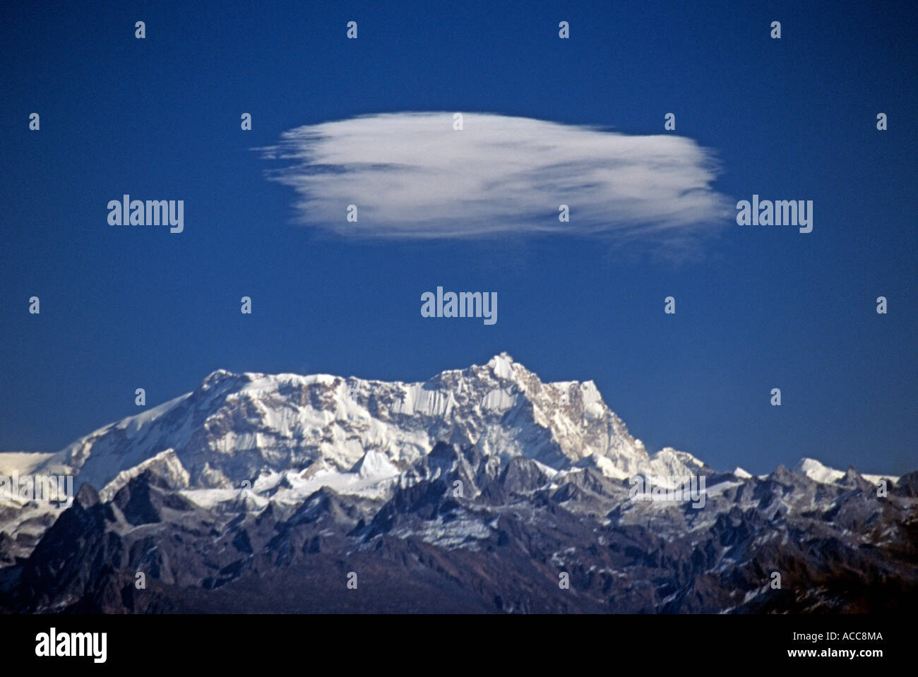 Single cloud floating over highest mountain in Bhutan Stock Photo - Alamy