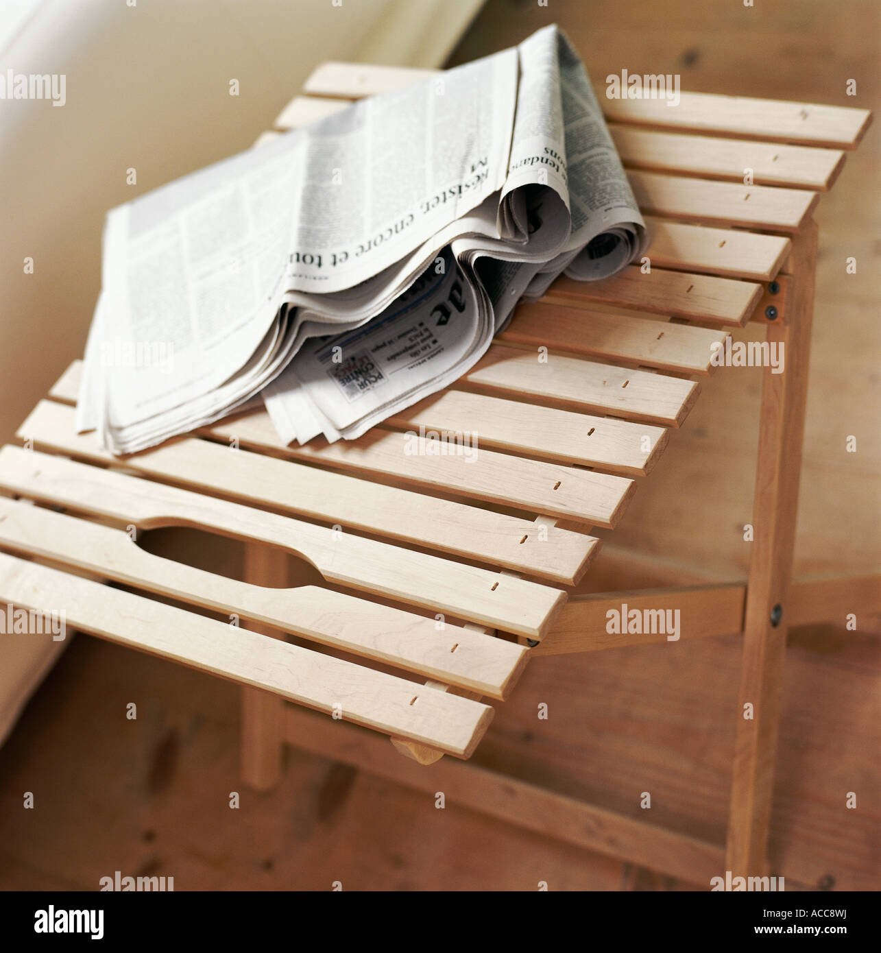 A newspaper on a stool Stock Photo - Alamy