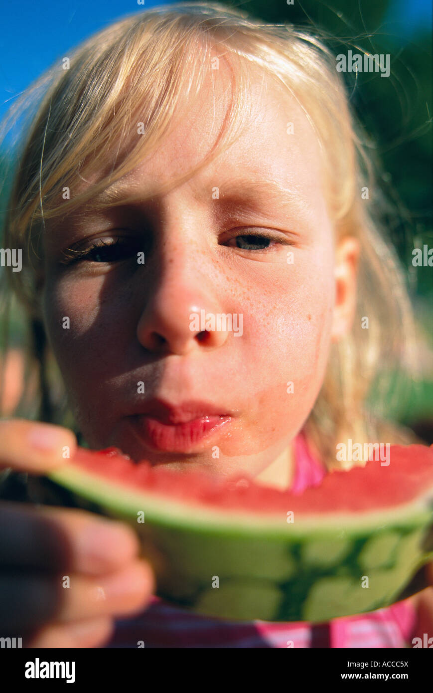 A girl eating a watermelon Stock Photo - Alamy