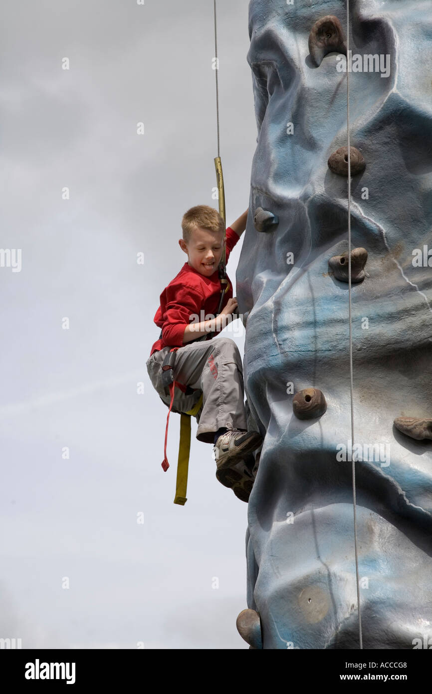 Child learning to rock climb on a training pillar Wales UK Stock Photo ...