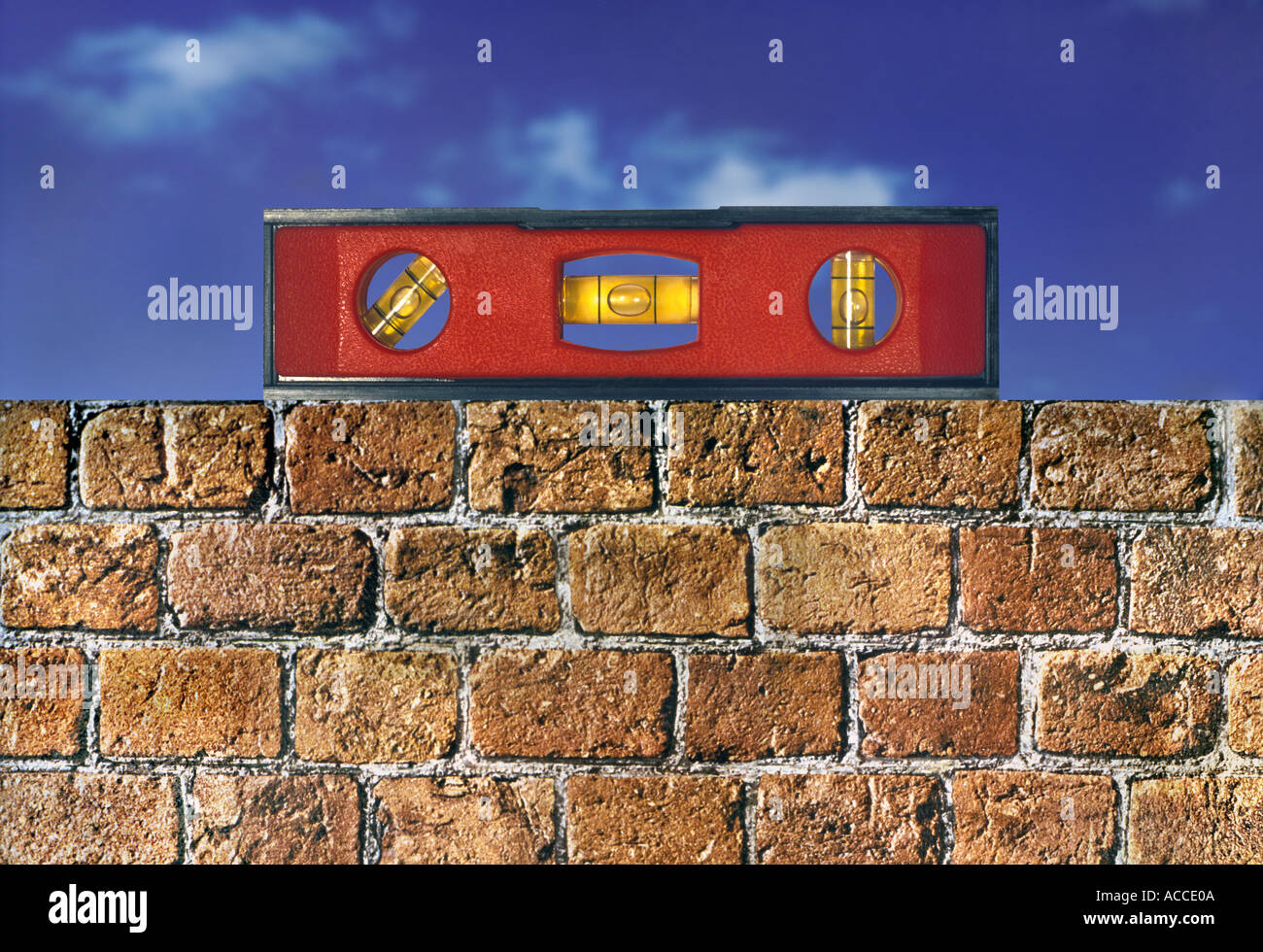 spirit level on top of brick wall with sky background Stock Photo - Alamy