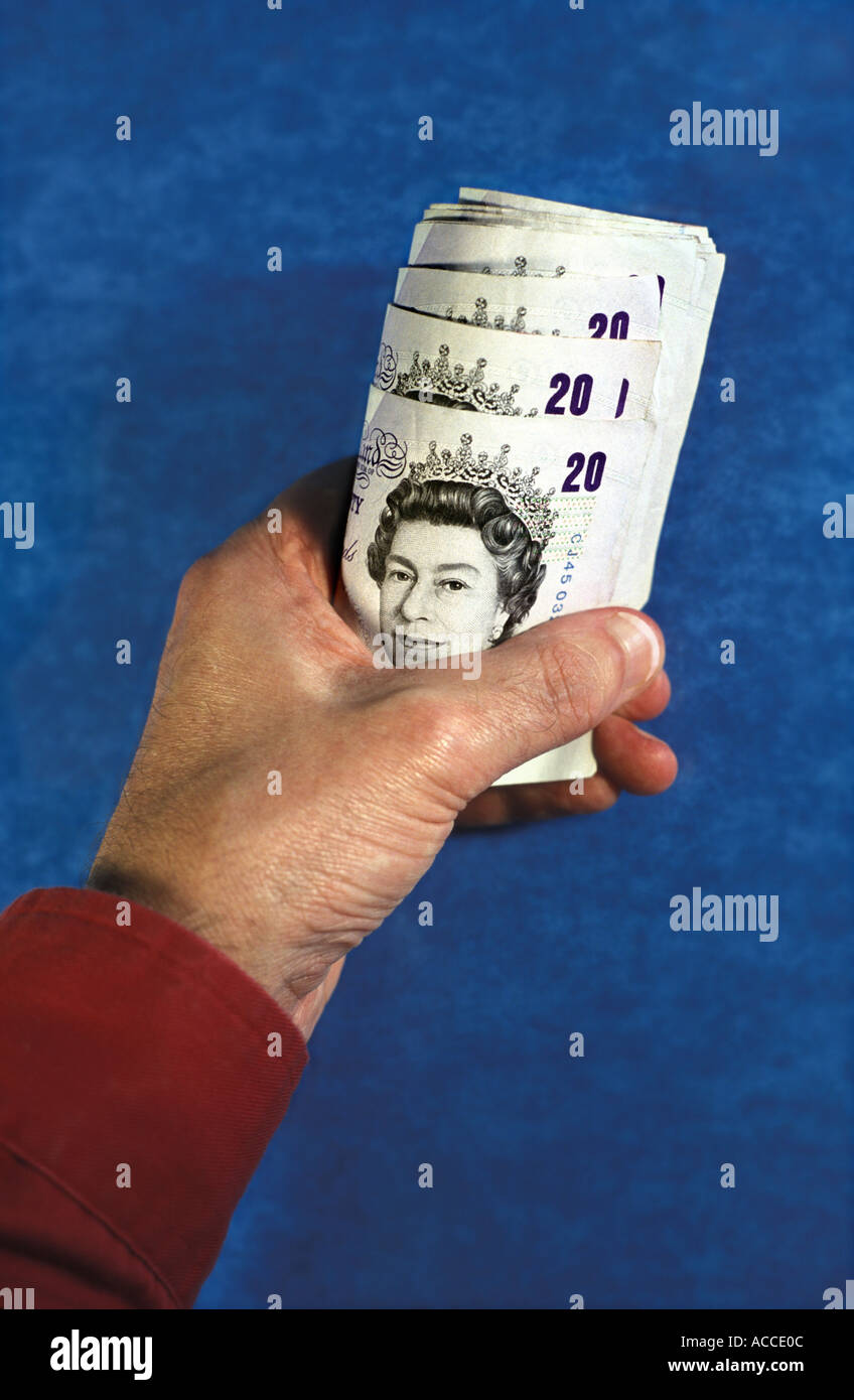 hand holding UK Pound banknotes Stock Photo - Alamy
