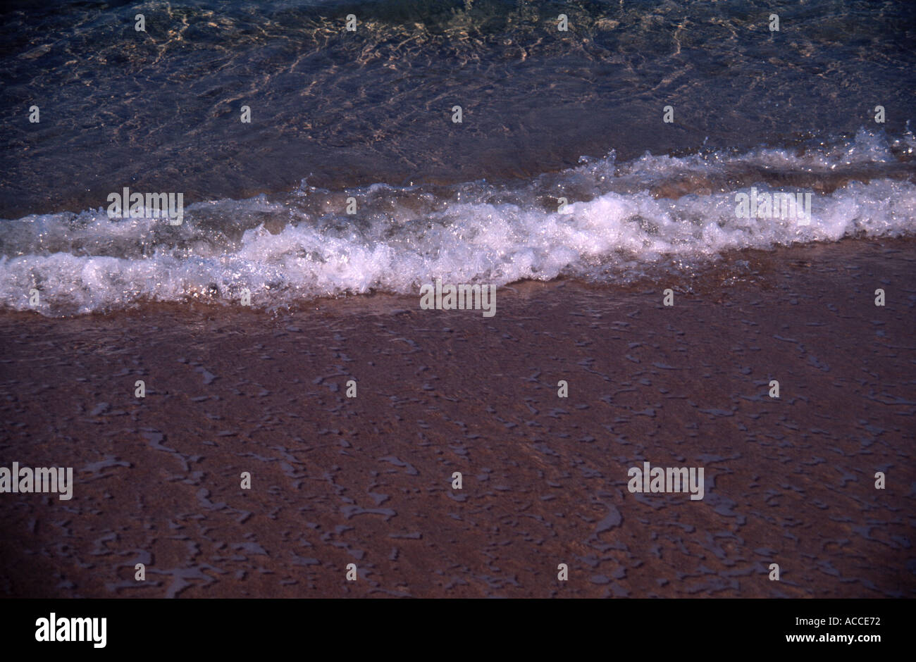 Edge of sea with small waves rippling onto beach Stock Photo - Alamy