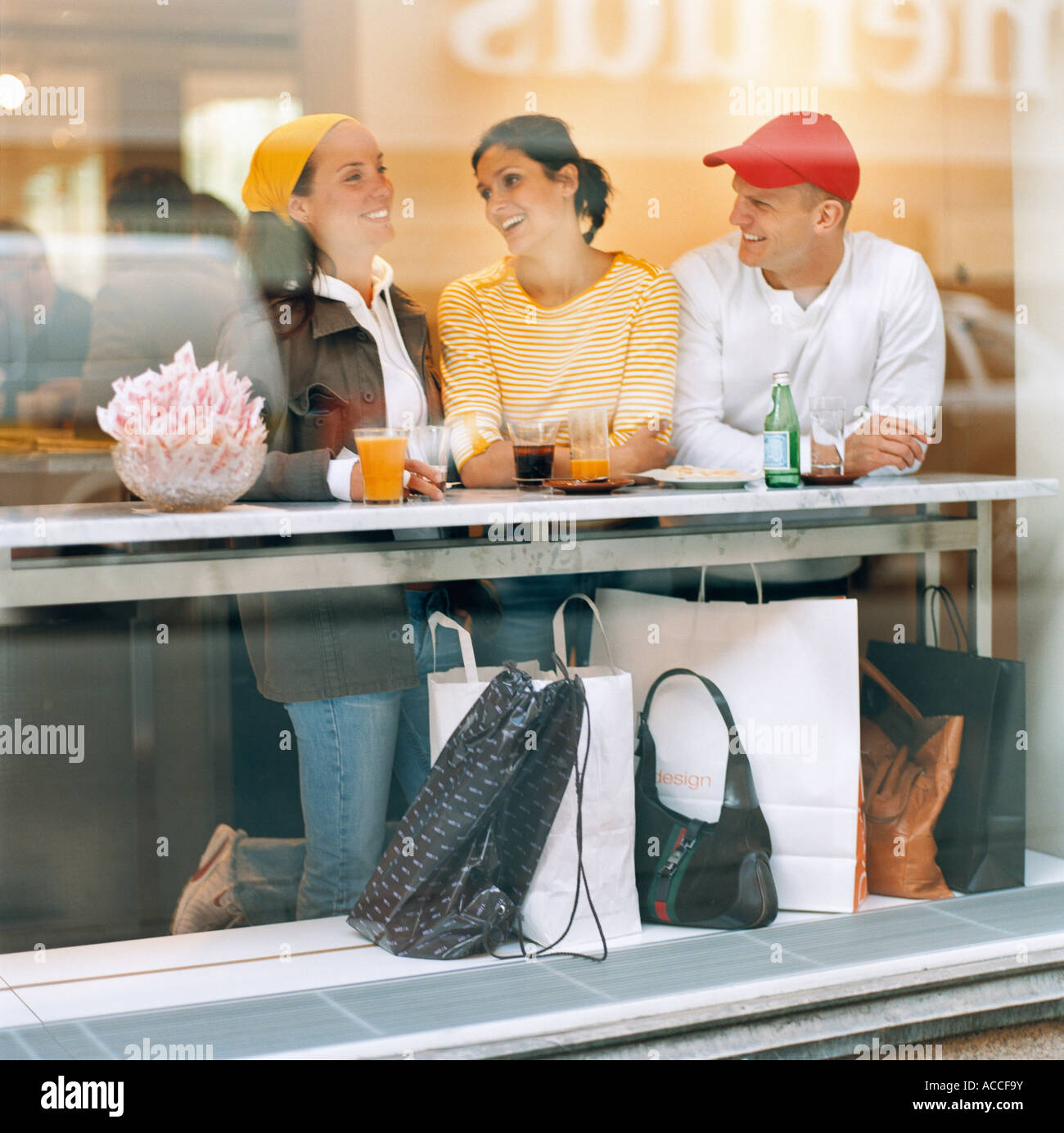 Three people talking in a café Stock Photo - Alamy