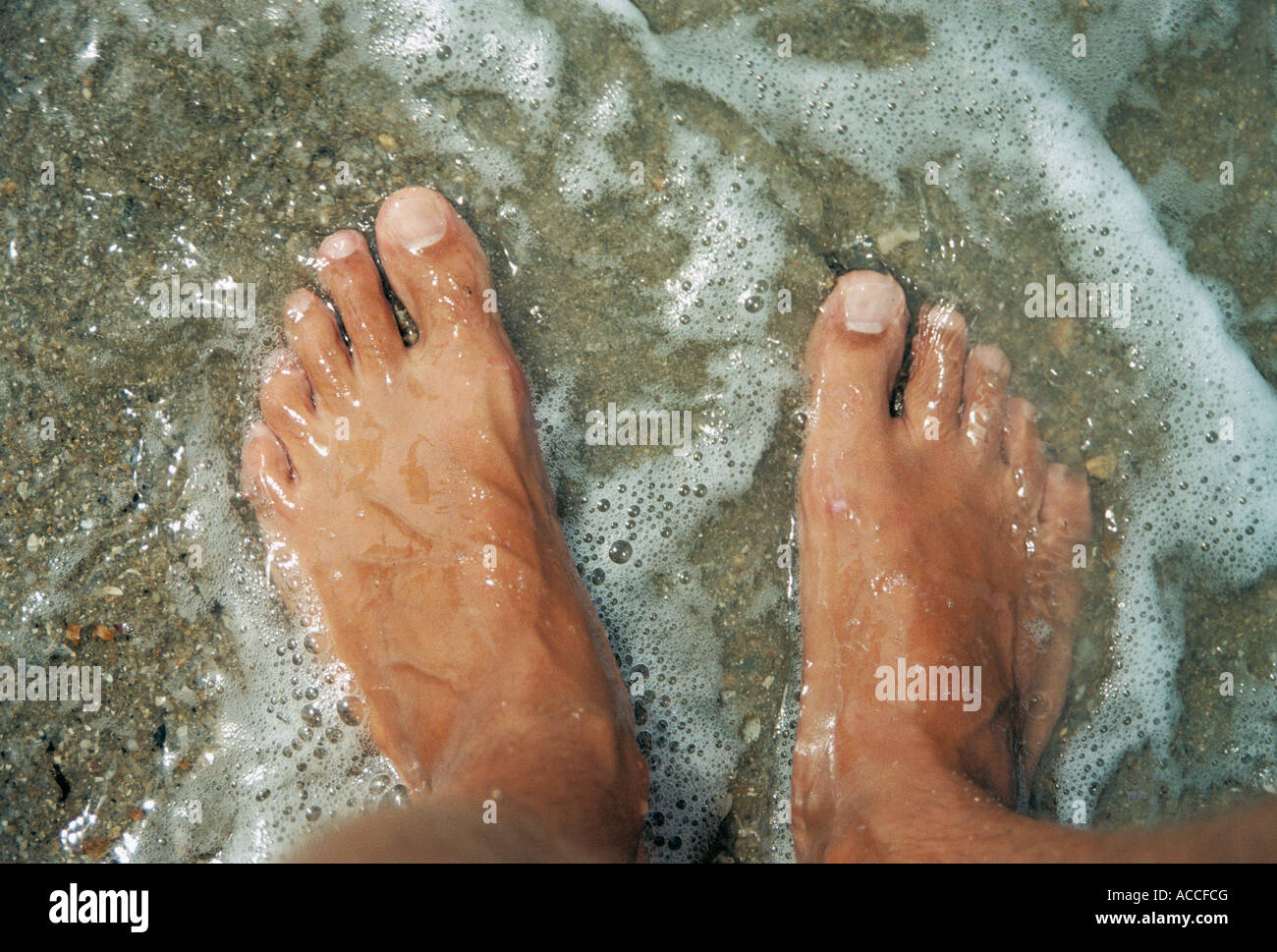 Waves on bare feet Stock Photo - Alamy