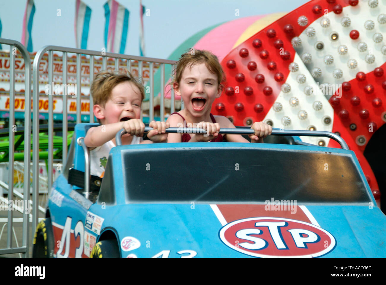 Children scream yell and shout while enjoying thrilling rides at a ...