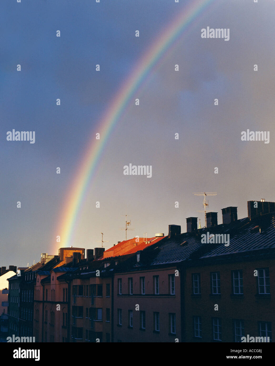 A rainbow over buildings Stock Photo - Alamy